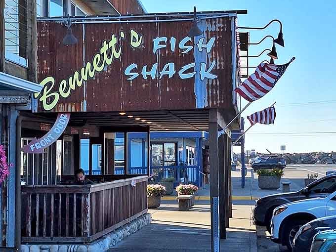 The patriotic flags and rustic charm create a postcard-perfect scene where fresh catch becomes crispy perfection daily.