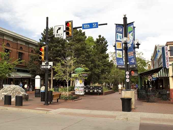 Tree-lined Pearl Street creates a peaceful urban oasis while those iconic street banners wave beneath clear skies.