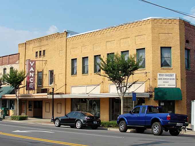 The old theater marquee and yellow brick facades remind you that some towns still value their heritage over cookie-cutter development.
