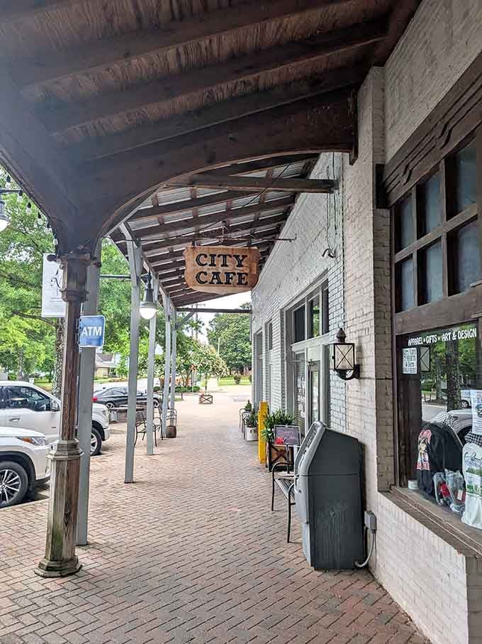 The covered sidewalk and vintage storefront create Main Street magic that makes you want to slow down and savor life.