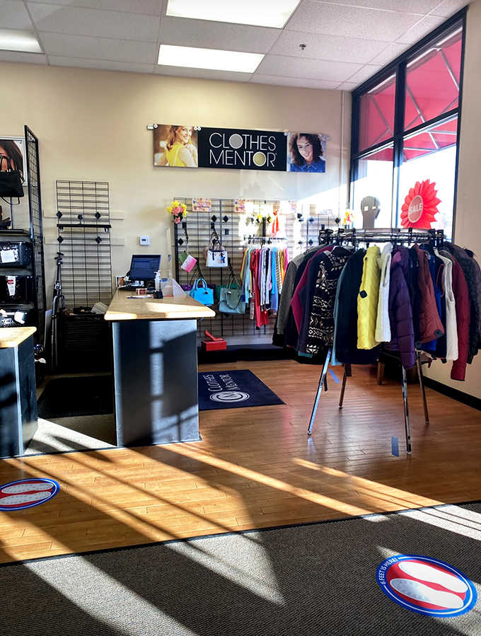Sunlight streams across polished floors highlighting curated clothing racks organized better than some department stores we know.