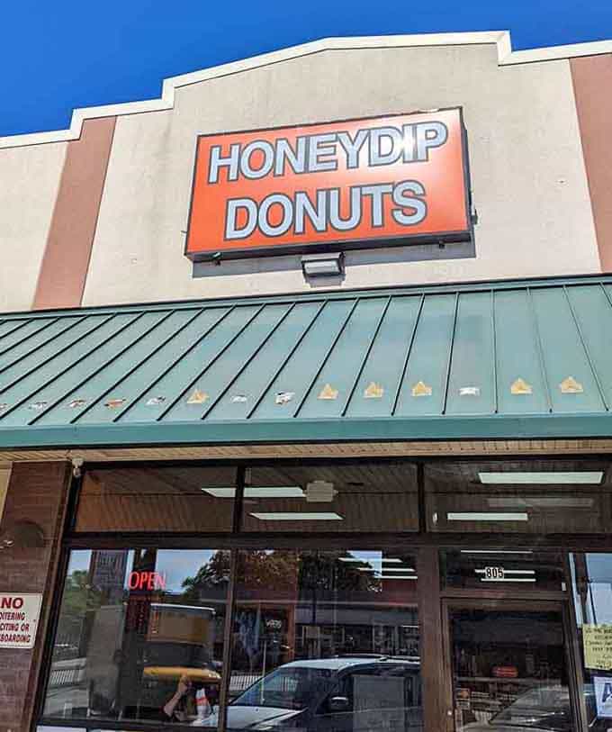 The green metal roof catches the light under blue skies, sheltering a donut shop that's sweeter than any treasure.