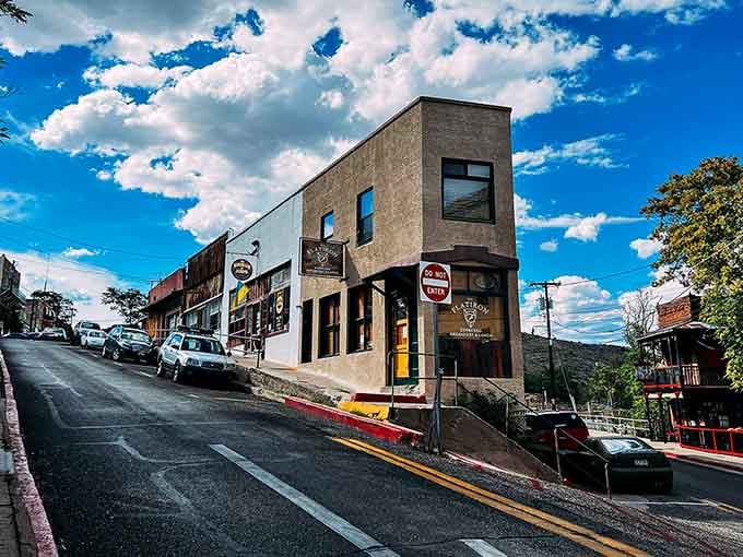 Steep streets climb toward cloudy skies where historic buildings cling to hillsides with impressive determination and character.