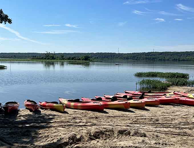 Colorful kayaks line up like eager students ready for recess, promising aquatic adventures across these sparkling waters ahead.