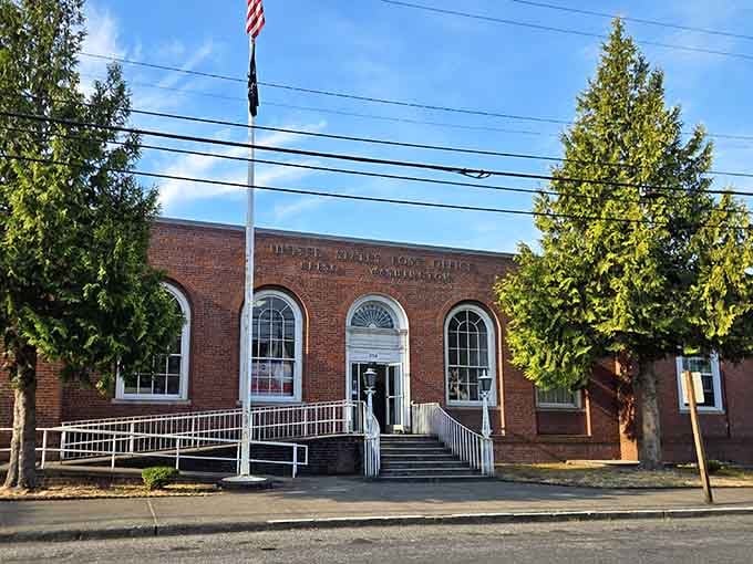 Classic brick architecture frames the street where American flags wave and community pride runs deep as the Columbia.