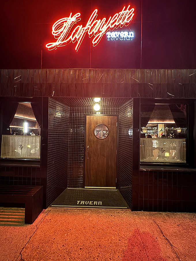 Lafayette's vintage neon sign lights up like a Vegas showgirl, promising tavern warmth and steakhouse excellence within.