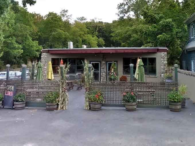 The rustic patio setup with barrel planters gives off serious countryside charm mixed with sophisticated dining vibes you'll absolutely love.