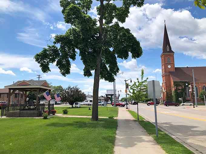 A peaceful gazebo anchors the town square where summer concerts and community gatherings create memories under shady trees.