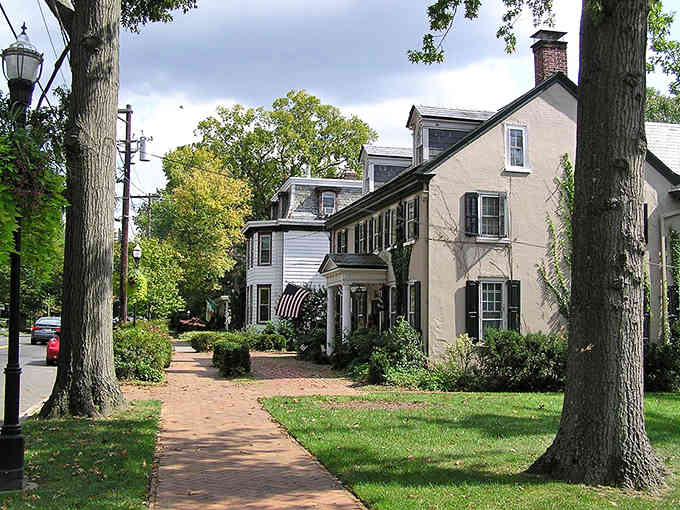 Brick walkways beneath towering trees create the perfect setting for a leisurely stroll between courses and coffee stops.