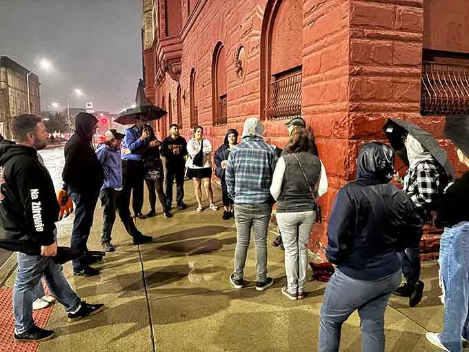 Ghost tour groups gather at dusk where Detroit's spooky stories come alive under the streetlights and shadows.