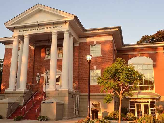 Classical columns frame the entrance to culture and community, glowing warmly as the golden hour works its magic.