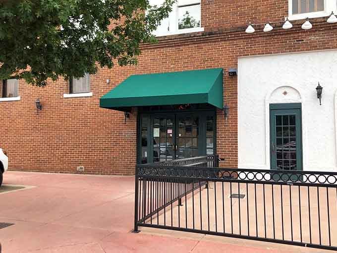 Behind that green awning and wrought-iron railing lies proof that the best meals often hide in plain sight.