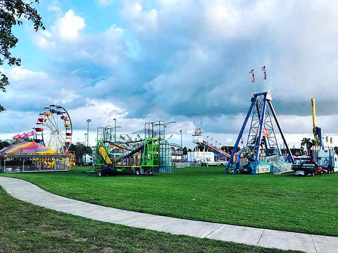 Carnival rides stand ready against dramatic skies, promising the kind of old-fashioned fun that never goes out of style.