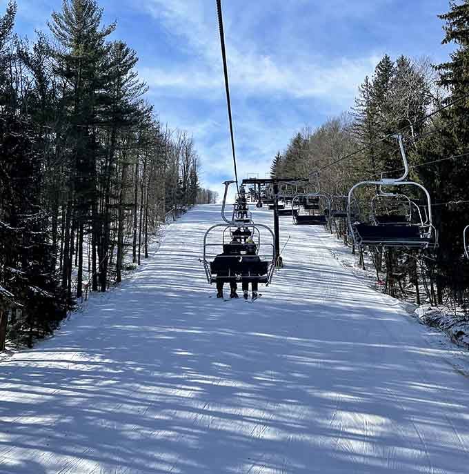 The ski lift carries winter enthusiasts up pristine slopes where fresh powder and blue skies await.