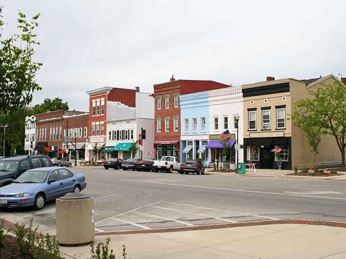 Dramatic clouds frame historic buildings that have weathered storms and celebrations, standing strong through generations of Main Street memories.
