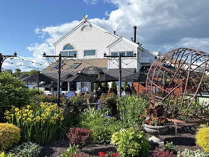Vibrant gardens frame the waterfront setting like nature's own welcome mat rolled out for seafood lovers everywhere.