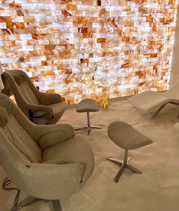 That stunning salt wall glows like precious amber while plush recliners promise the kind of comfort you'll dream about.