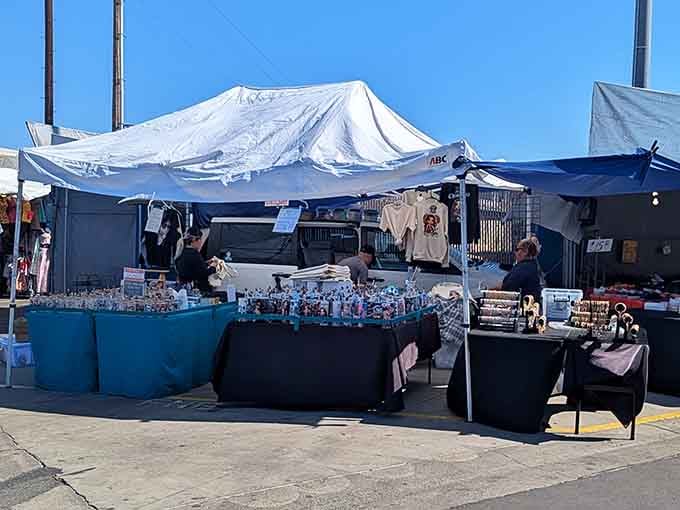 Tables overflow with glassware and collectibles that sparkle under the sun, each piece whispering stories from decades past.