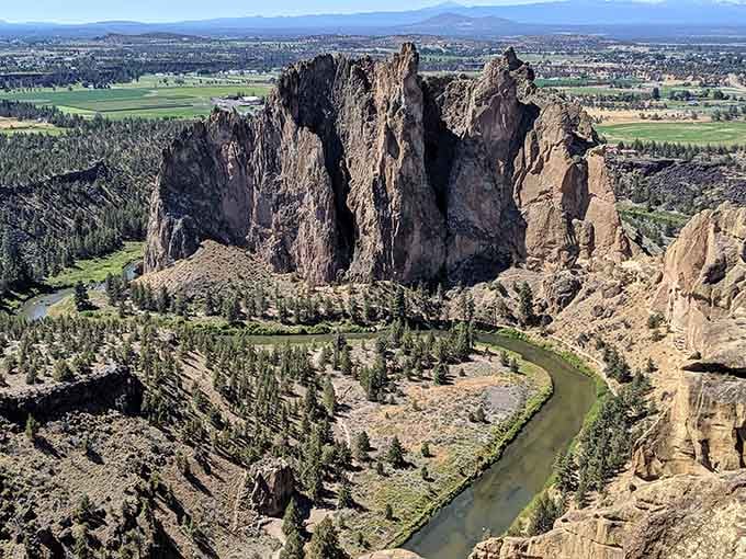 Jagged rock formations rise dramatically above the river valley, creating a landscape that belongs on another planet.