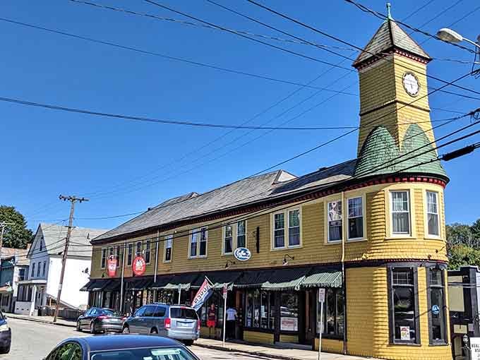 That cheerful yellow clock tower stands as a beacon of small-town charm where time moves just right.
