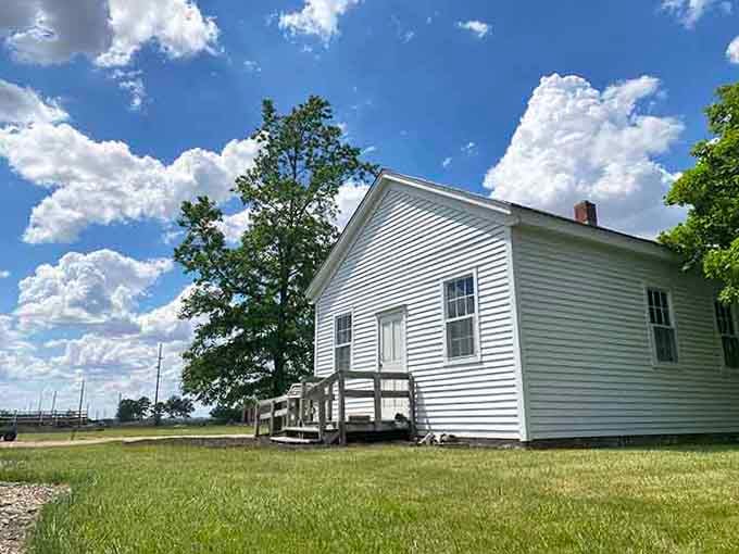 This pristine white building stands like a testament to pioneer determination, complete with wooden steps and endless blue skies.