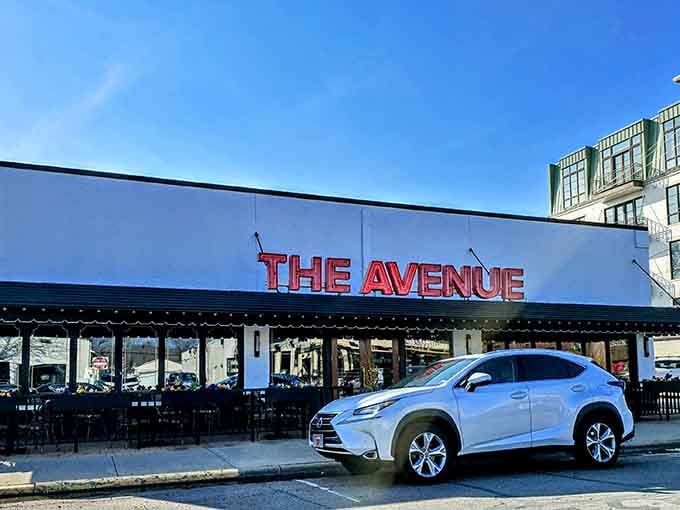 Clean lines and bright signage mark this corner spot where modern steakhouse energy meets approachable tavern warmth perfectly.