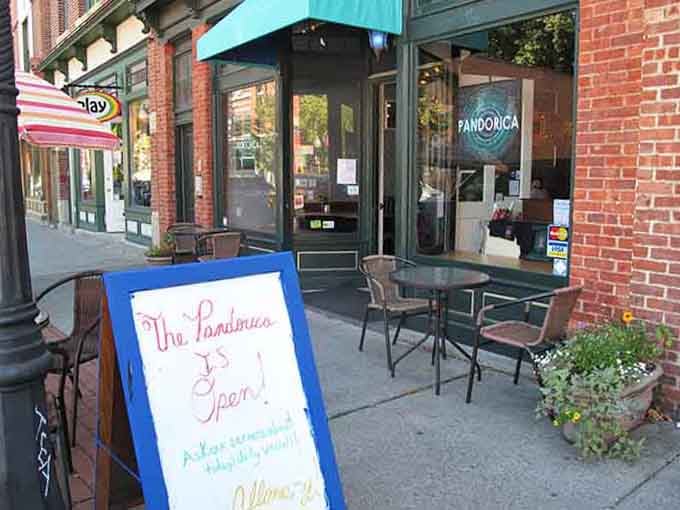 The welcoming sidewalk setup with cheerful signs promises the kind of neighborhood cafe where everybody knows your coffee order.