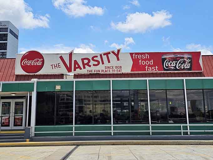 The Varsity's classic facade gleams under blue skies, promising the same delicious experience generations have loved since 1928.