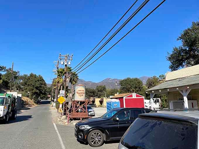 Vehicles line up outside this vintage storefront where travelers know the food inside matches the building's timeless appeal.