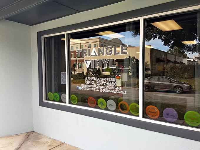 Colorful vinyl records line the window like a rainbow, each one a portal to somebody's favorite musical memory.