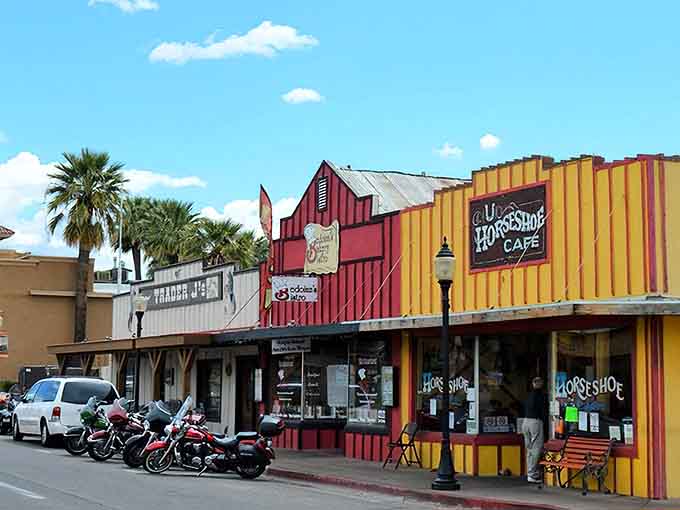 Those motorcycles parked outside colorful shops tell you this town welcomes adventurers seeking authentic desert experiences.