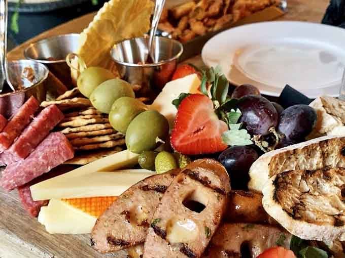 This cheese and meat board arrives looking like edible art, complete with strawberries playing the supporting role.