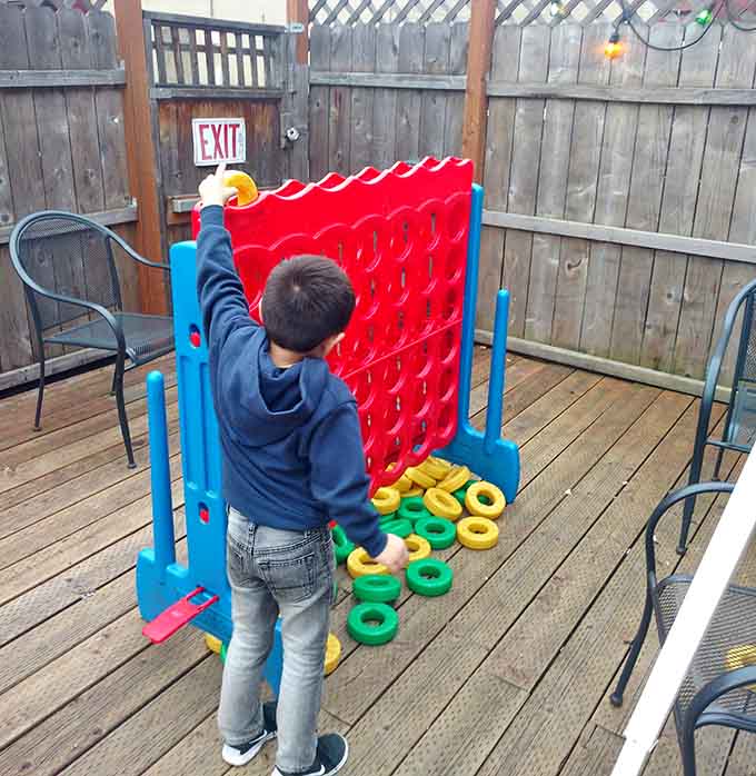 Giant Connect Four on the patio proves that sometimes the best games don't need electricity, just strategy and smack talk.