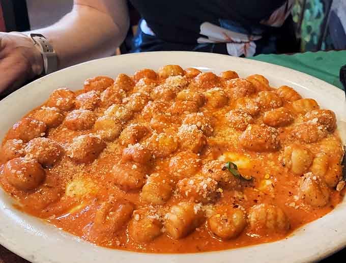 Gluten-free gnocchi swimming in tomato sauce proves dietary restrictions don't mean flavor restrictions at all here.