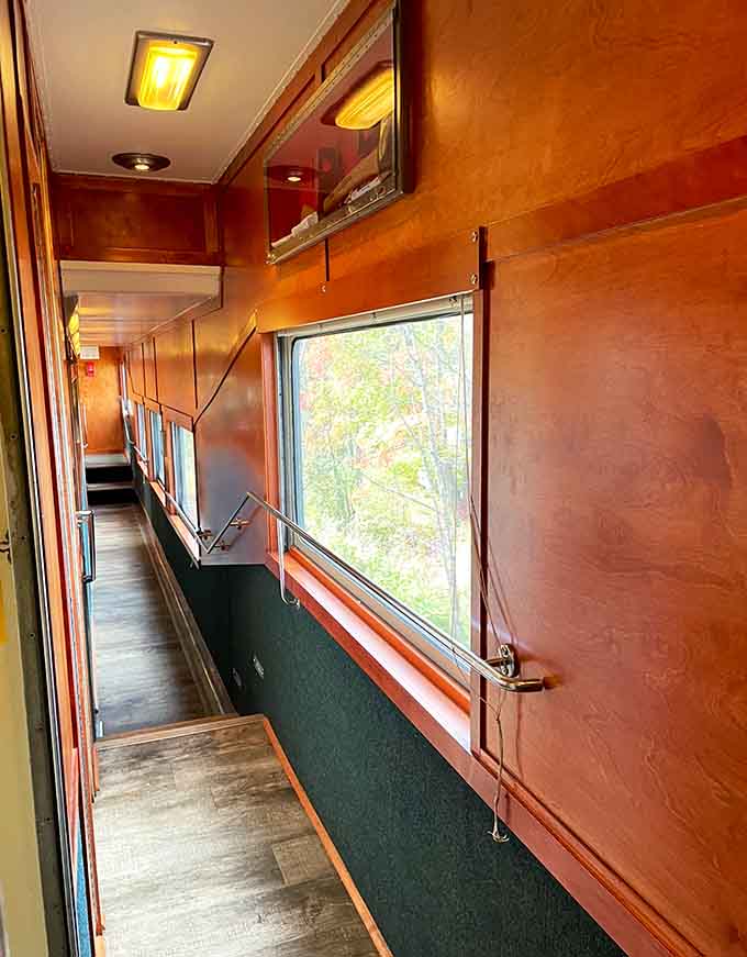 Wood-paneled corridors and generous windows create the perfect vintage train atmosphere for your Adirondack adventure.