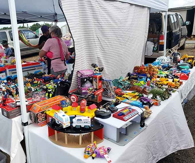 Toys scattered under a tent like a garage sale met a toy store and decided to have the world's most colorful baby.
