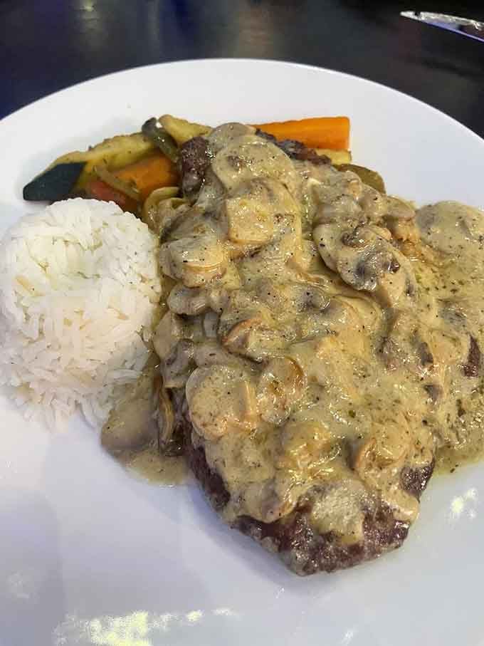 Schnitzel draped in mushroom cream sauce, proving that comfort food doesn't need to apologize for being absolutely spectacular and indulgent.