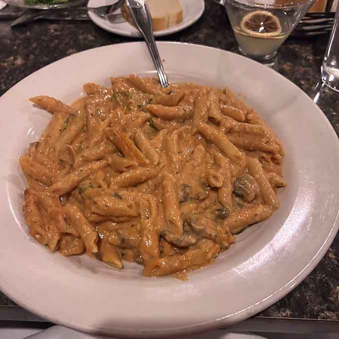 Cavatelli shells cradling mushrooms in red cream sauce like tiny edible treasure chests of flavor.