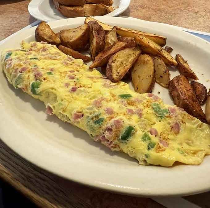 A Western omelet so loaded with goodness, it needs those home fries just to balance the plate.