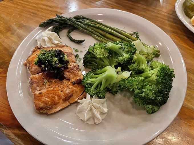 Grilled salmon with asparagus and broccoli&mdash;because even adventure seekers need to pretend they're eating healthy sometimes.