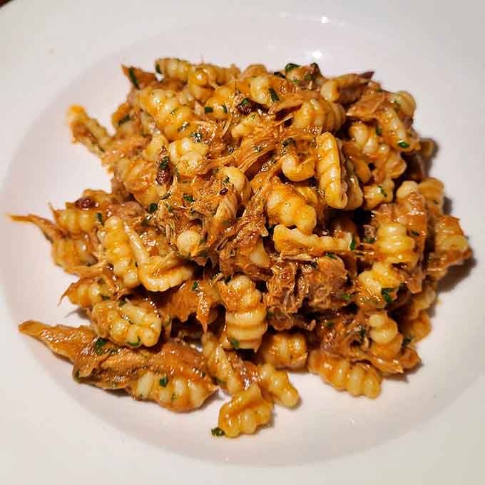 Cavatelli nestled with what appears to be lamb, proving that pasta shapes really do matter in this world.