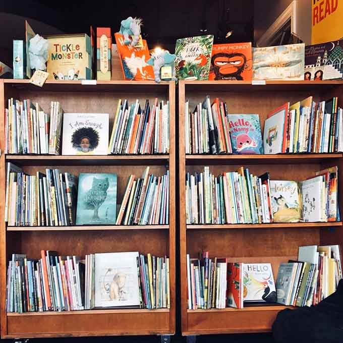 Picture books arranged at perfect kid height, inviting young readers into worlds of imagination and wonder.