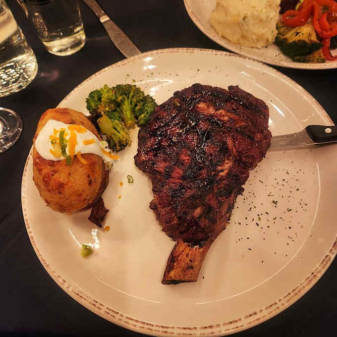 A bone-in ribeye so perfectly charred it looks like it graduated summa cum laude from steak university.