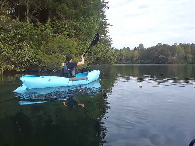 That bright blue kayak gliding across glass-calm water is your ticket to the kind of peace money can't buy.