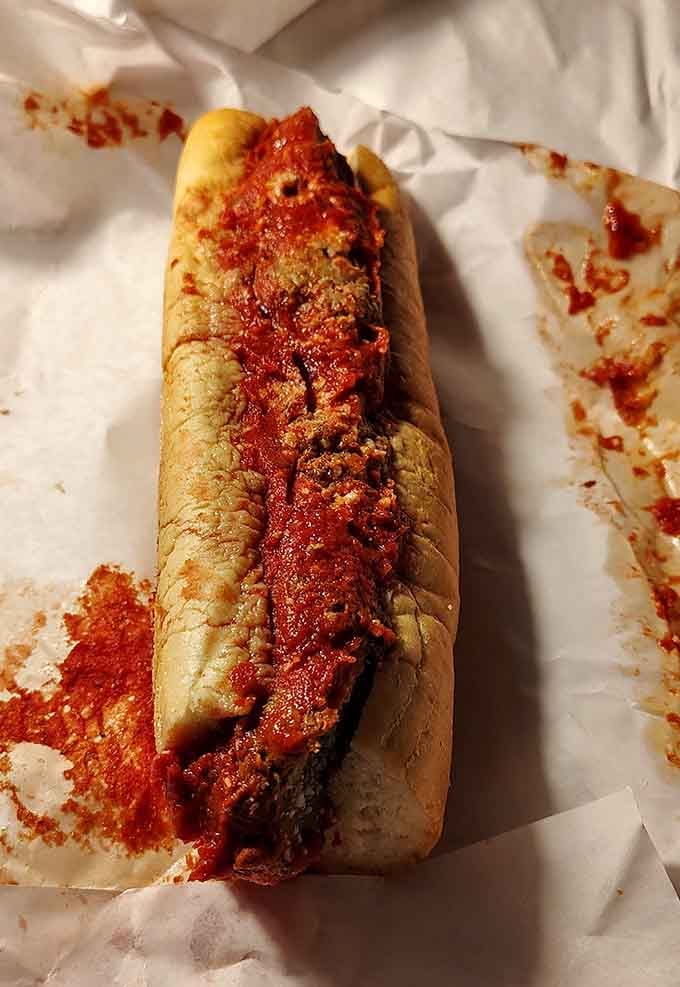 Meatballs swimming in marinara sauce, nestled in bread that somehow holds this saucy situation together beautifully.