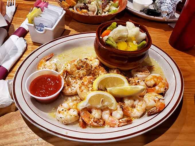 Perfectly seasoned shrimp with fresh lemon wedges prove barbecue joints can handle surf and turf beautifully.