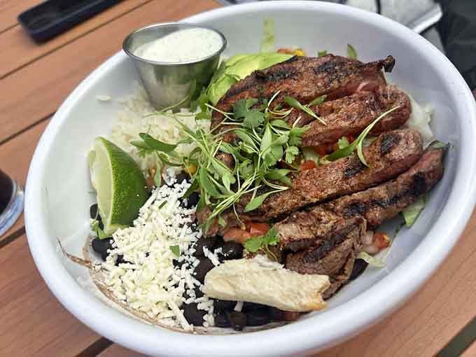 Sliced steak resting on black beans and rice with fresh lime wedges makes healthy eating look downright irresistible.