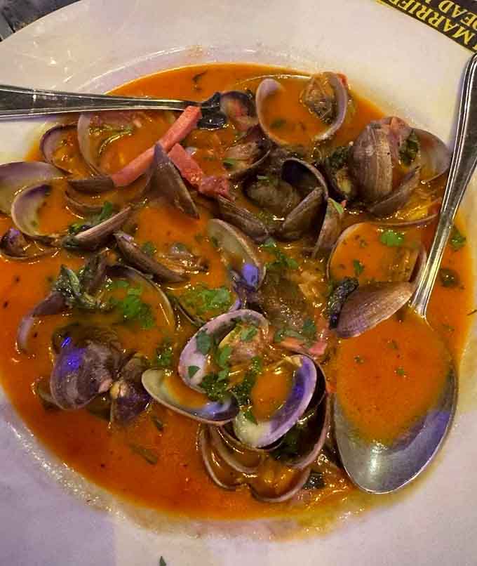 Fresh clams swimming in white wine butter sauce create the kind of dish that makes you forget table manners.