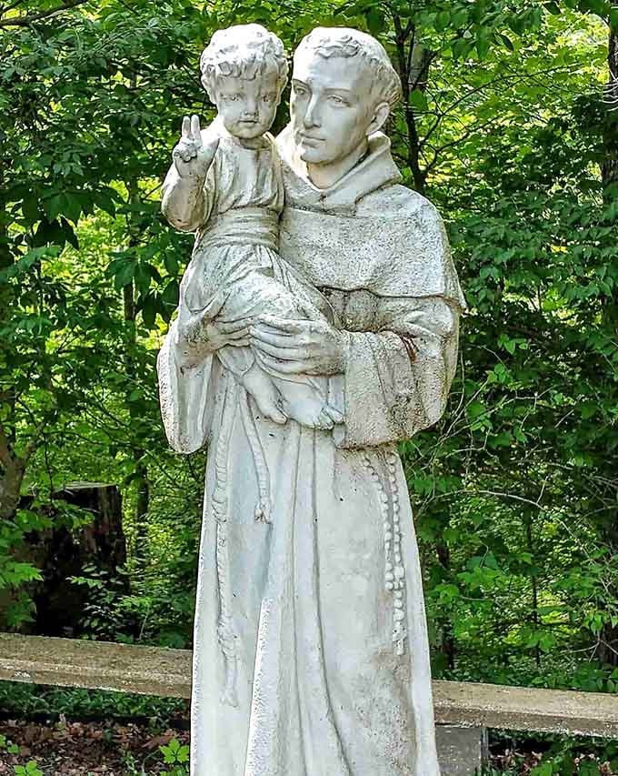 Saint Anthony of Padua keeps watch among the greenery, a timeless guardian in Missouri's rolling hills.