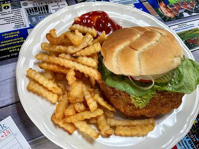 The breaded tenderloin sandwich arrives golden and crispy, ready to make you forget every diet you've ever attempted.